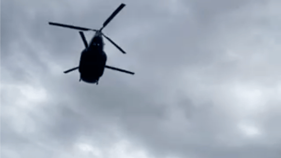 Watch the incredible moment a Chinook flies just metres over golfers at ...